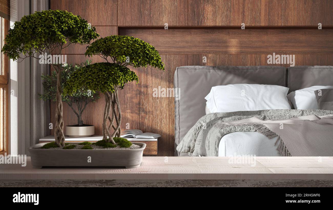 Vintage wooden table shelf with pebble and potted bloom bonsai, green flowers, over minimalist ...