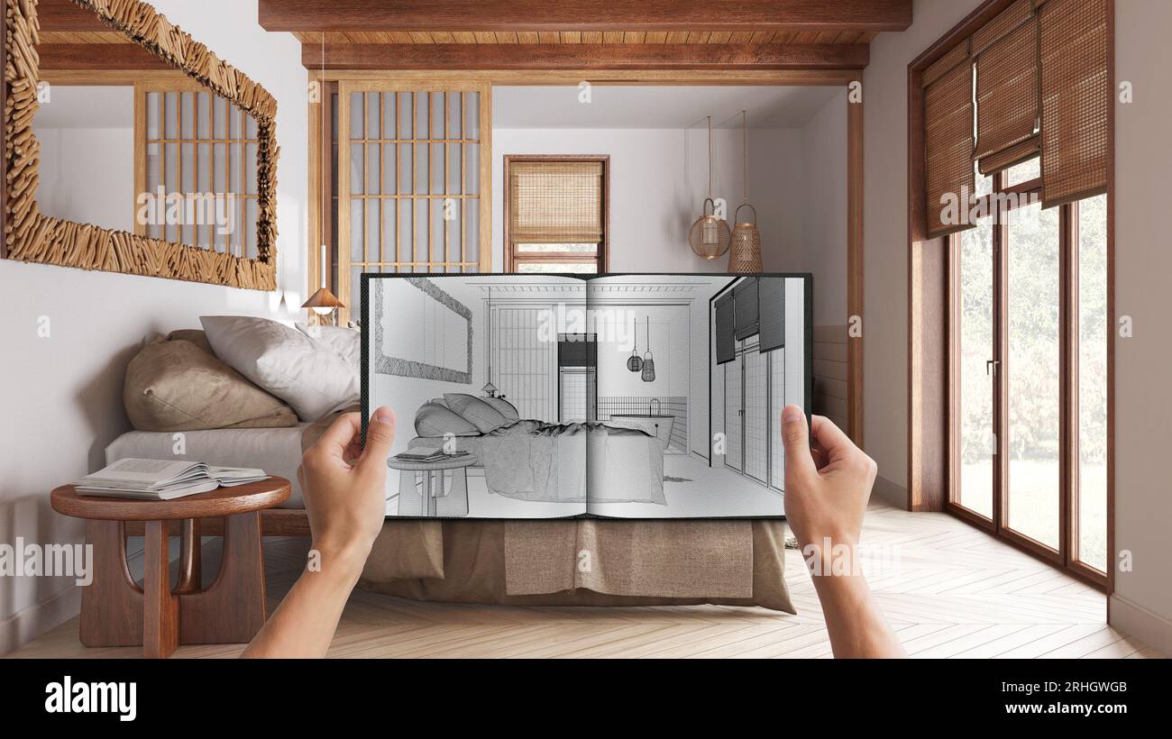 Hands holding notepad with japandi bedroom design blueprint sketch or drawing. Real interior ...