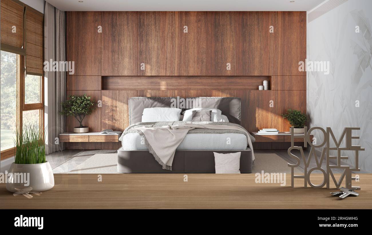 Wooden table, desk or shelf with potted grass plant, house keys and 3D letters home sweet home ...