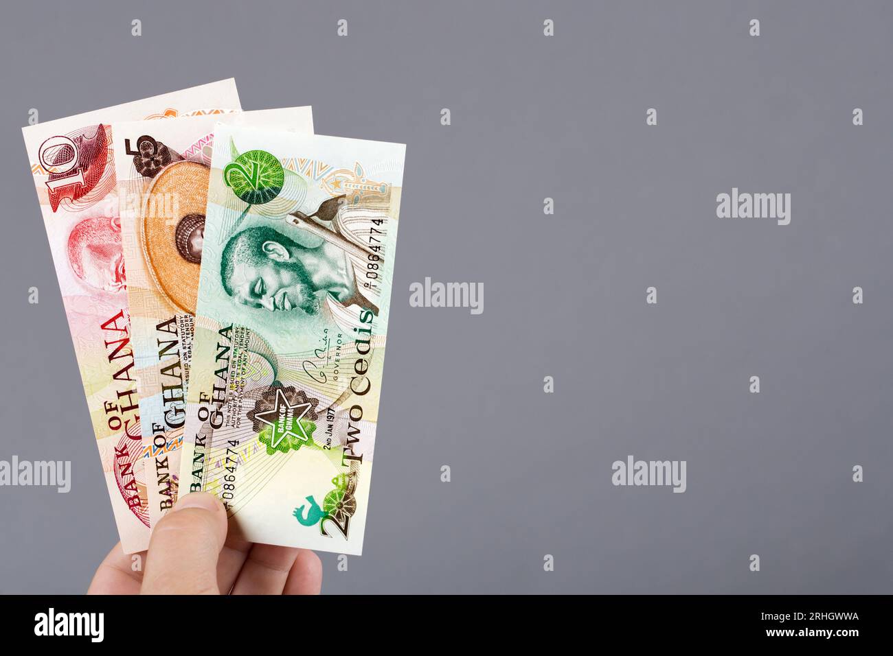 Old Ghanaian money - cedi in the hand on a gray background Stock Photo ...