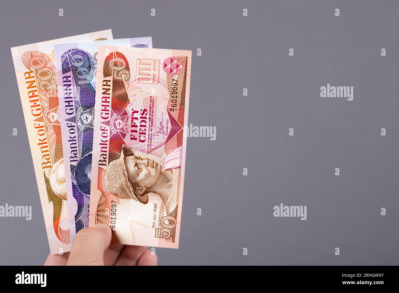 Old Ghanaian money - cedi in the hand on a gray background Stock Photo ...