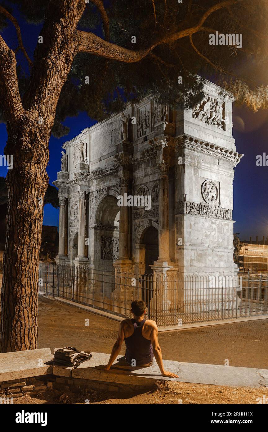 Arch of Constantine with seated tourist observing the monument Stock ...