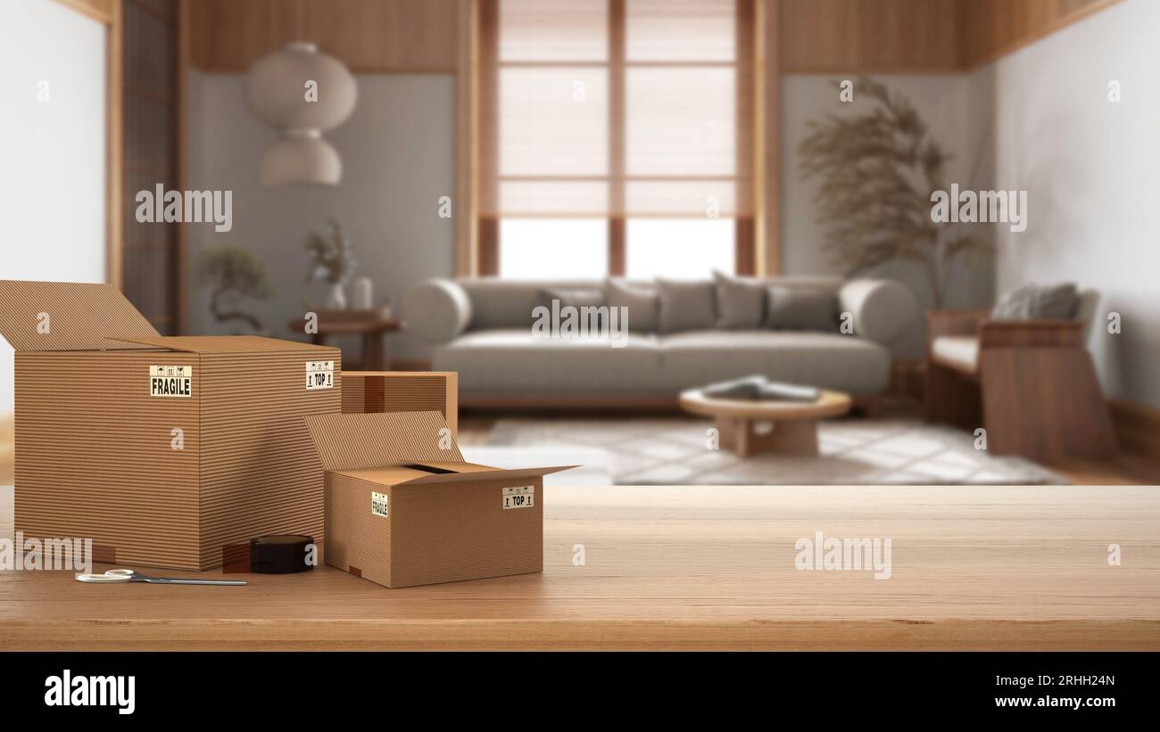 Wooden table, desk or shelf with stack of cardboard boxes over blurred ...