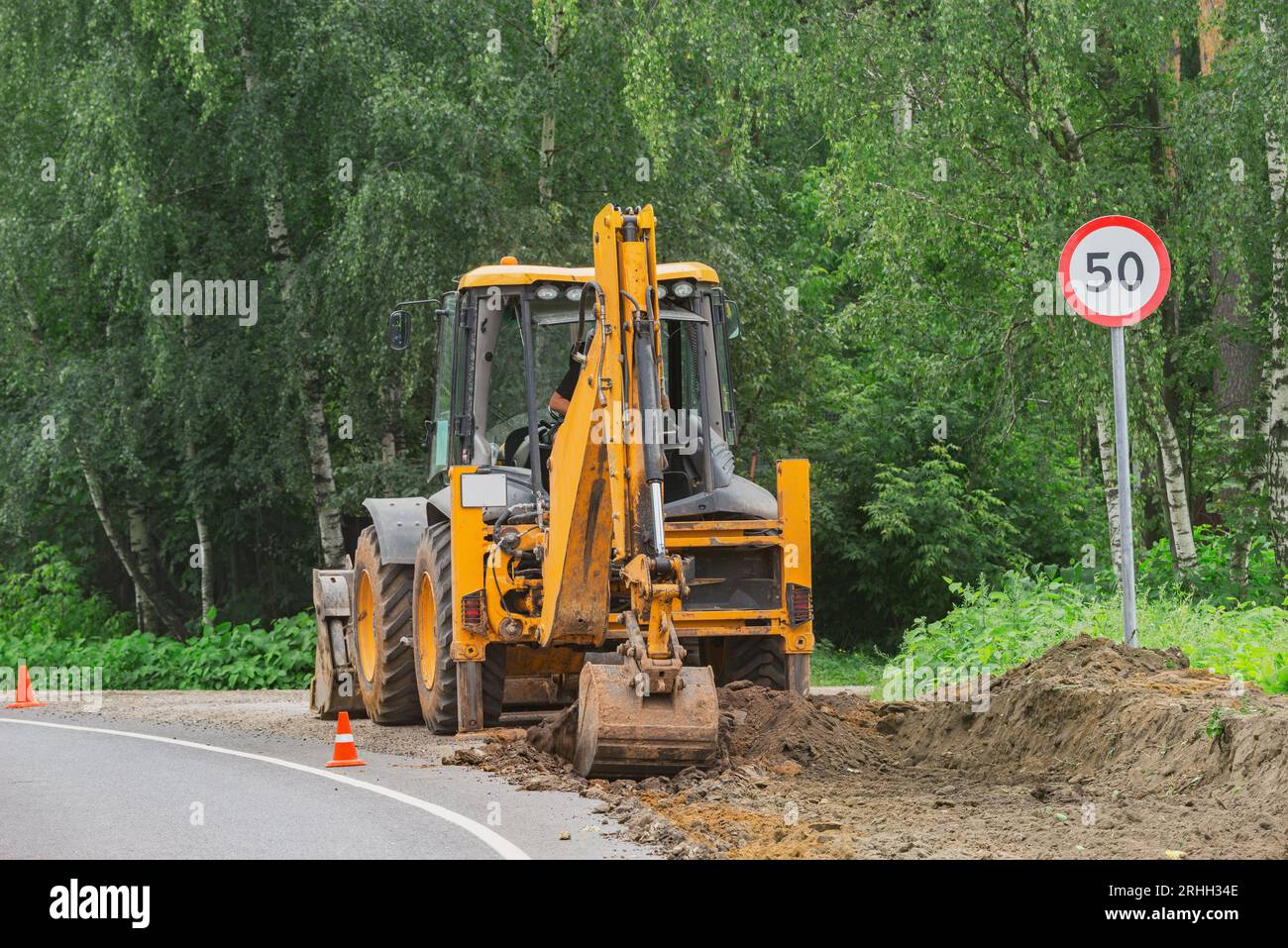 Road machine works by the highway Stock Photo - Alamy