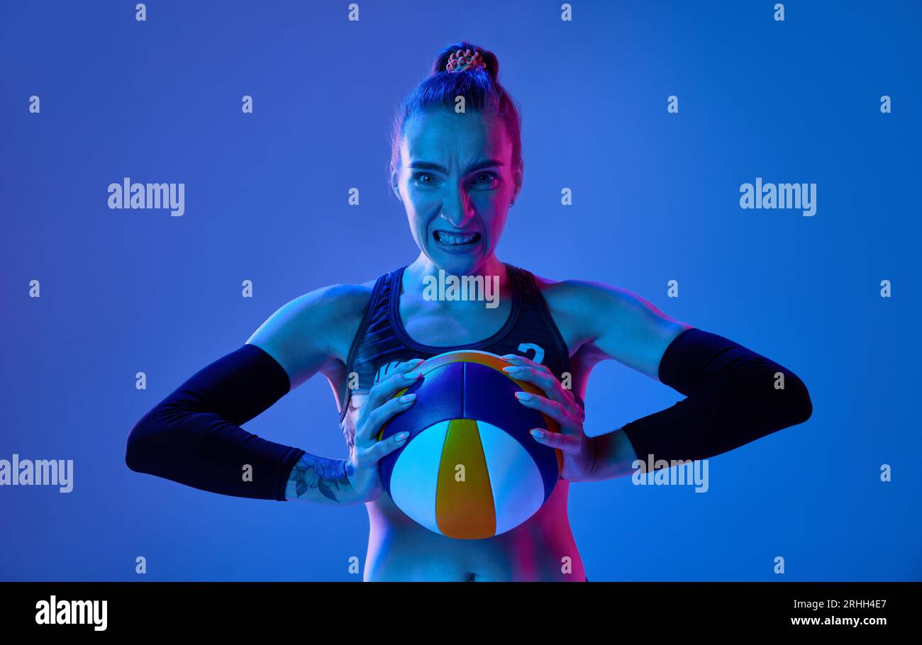 Emotional young woman, professional volleyball player standing with ...