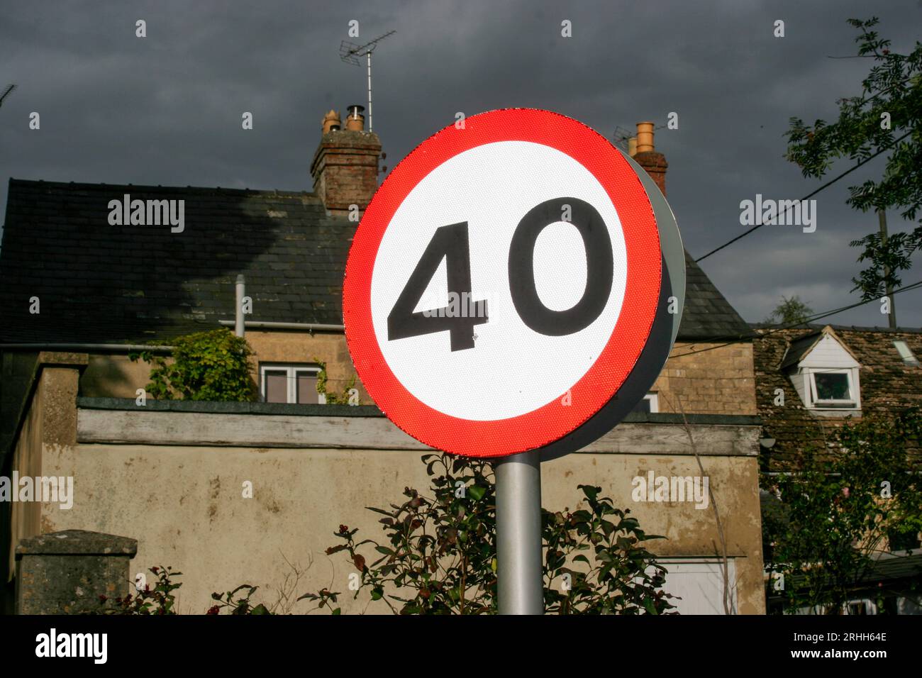A road sign on the side of a road detailing the speed limit of 40 miles ...