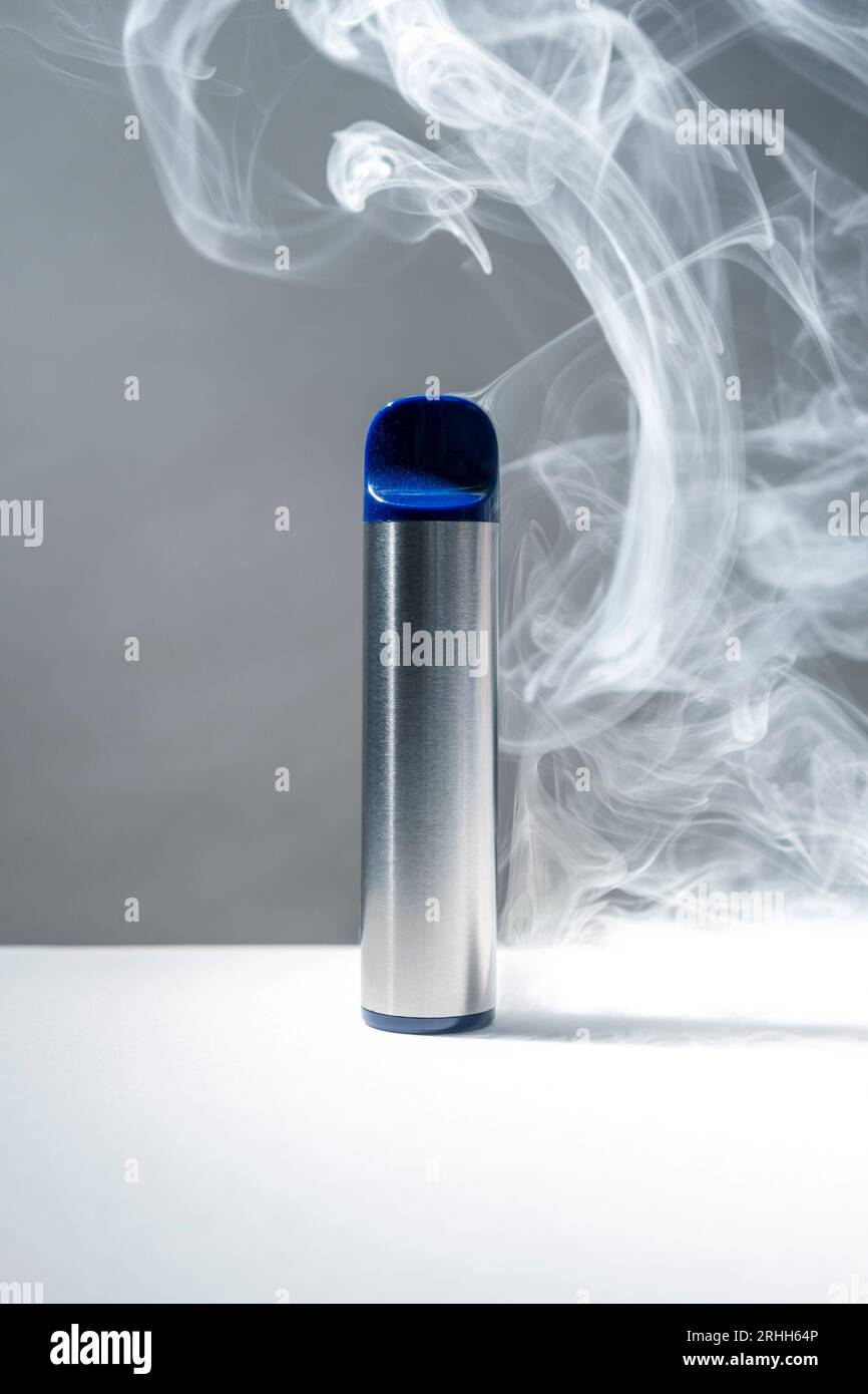 Still life studio shot of small vape pipe with vapor swirling around ...