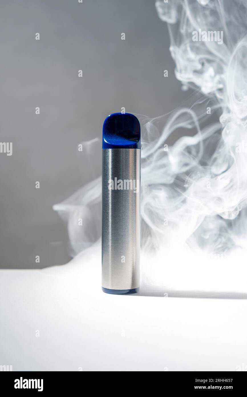 Still life studio shot of small vape pipe with vapor swirling around ...