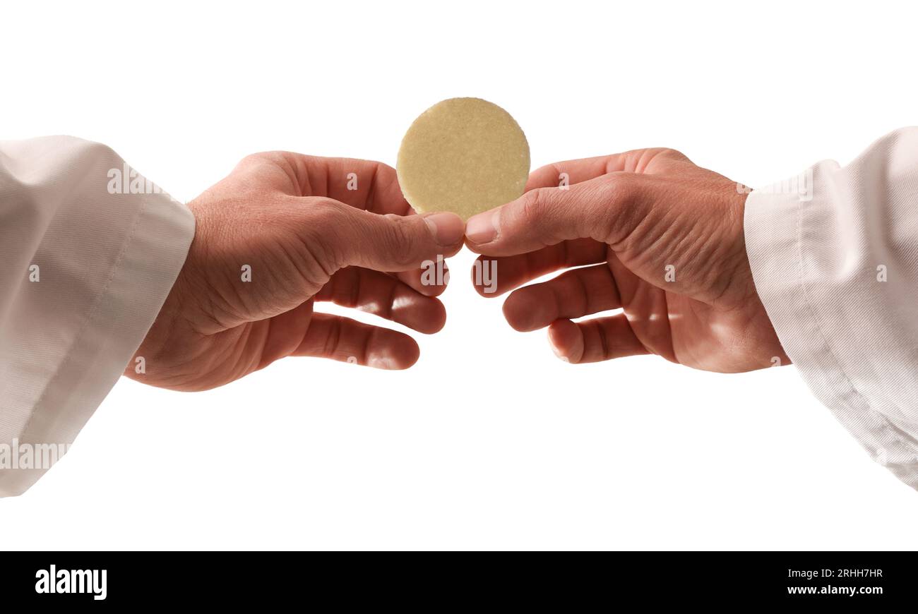 Hands of a priest consecrating a host as the body of Christ to ...