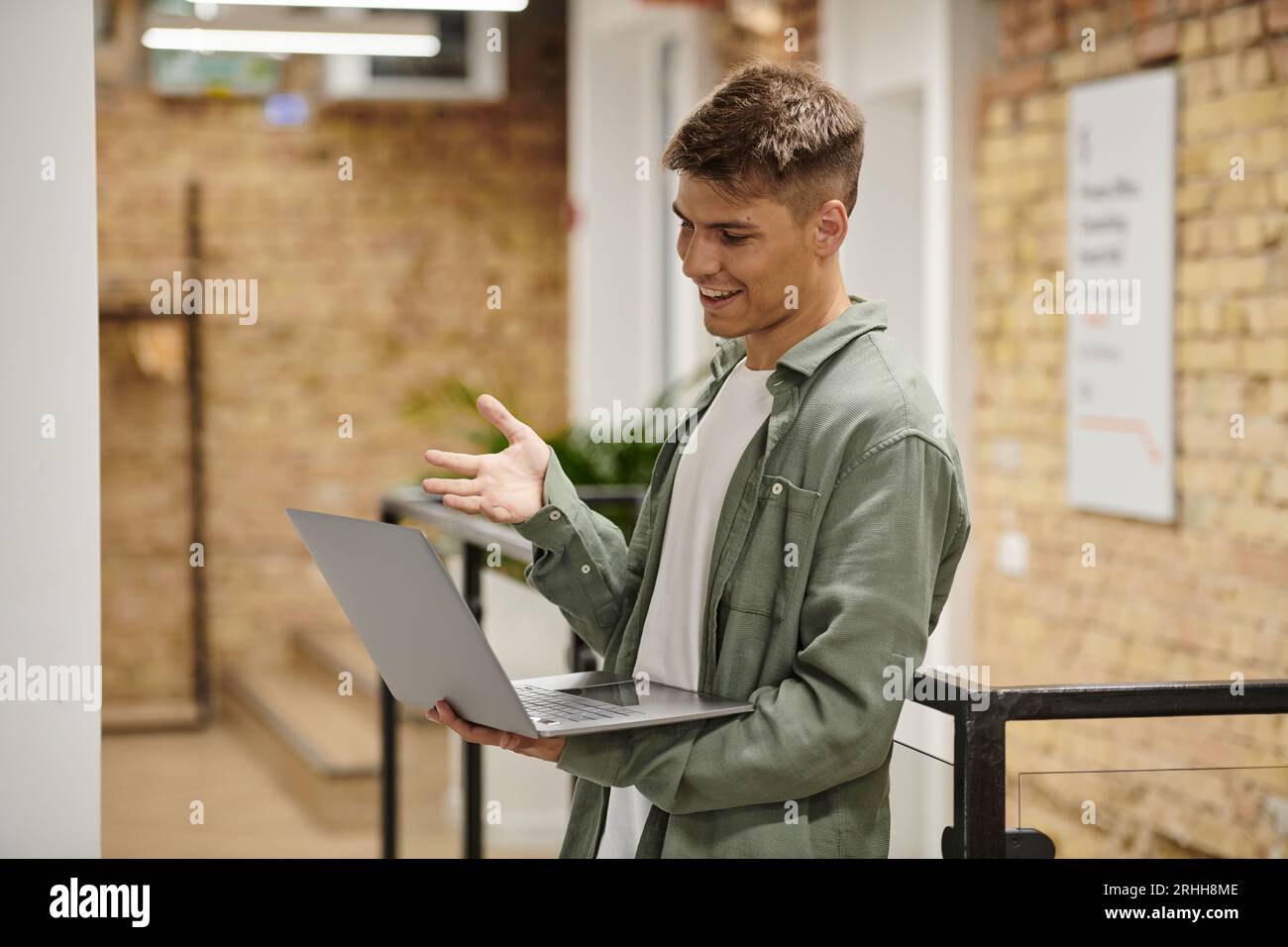 happy man using laptop, video call, modern coworking, office ...