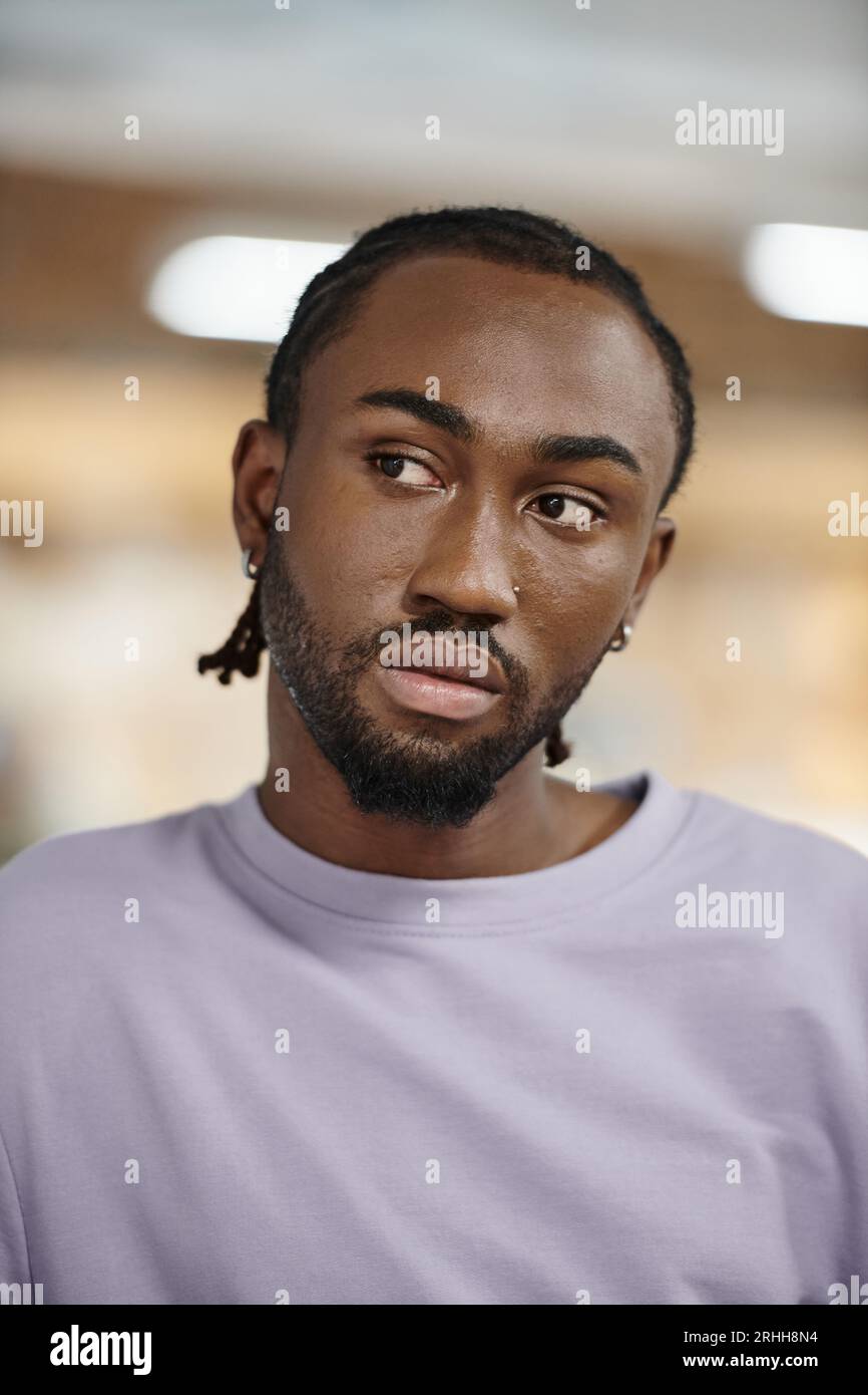 portrait, african american man in purple sweatshirt looking away ...