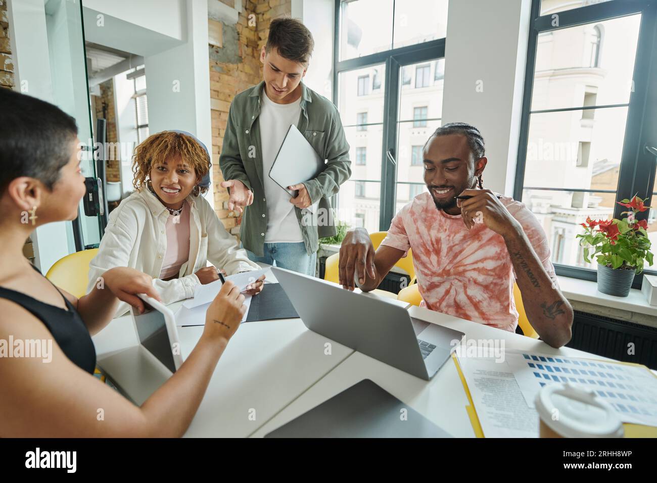 brainstorming, diverse team using gadgets and sharing ideas about ...