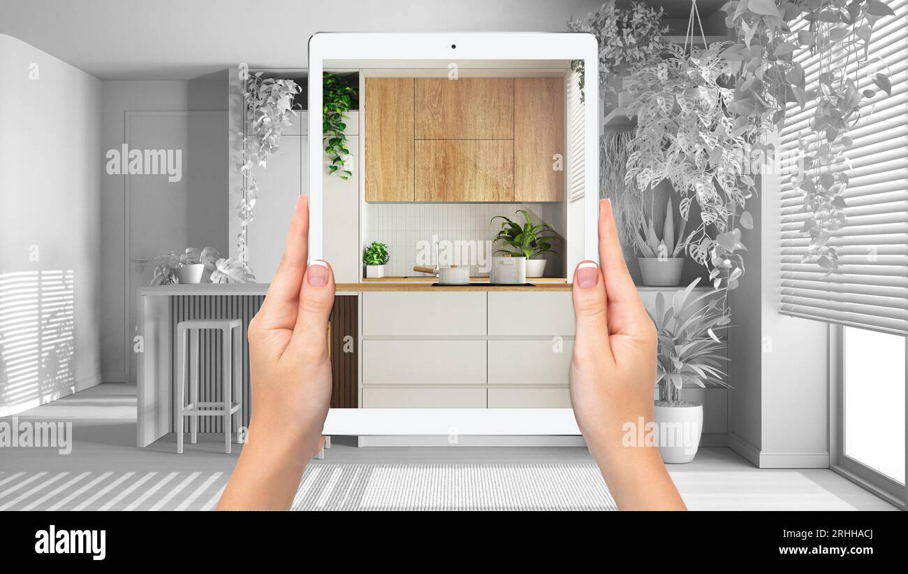 Hands holding tablet showing minimal kitchen, total blank project ...