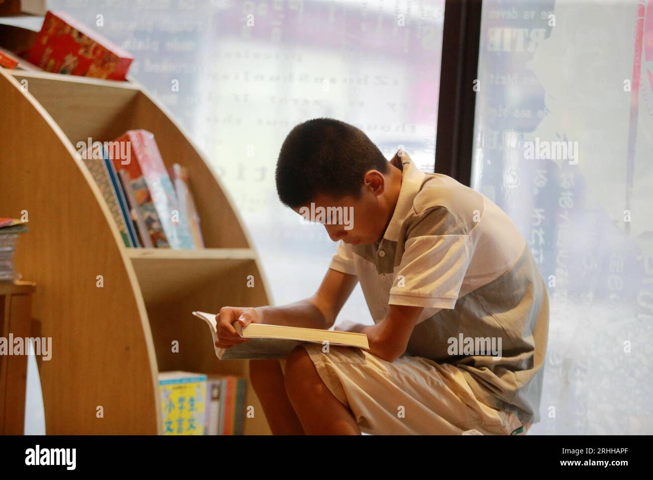 Children read books at Zhongshuge bookstore during summer vacation in Yangzhou City, east China ...