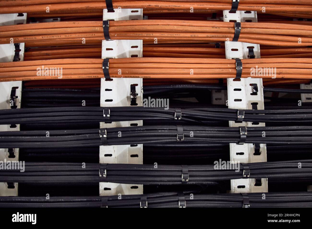 Power network orange and black cables joined in groups Stock Photo - Alamy