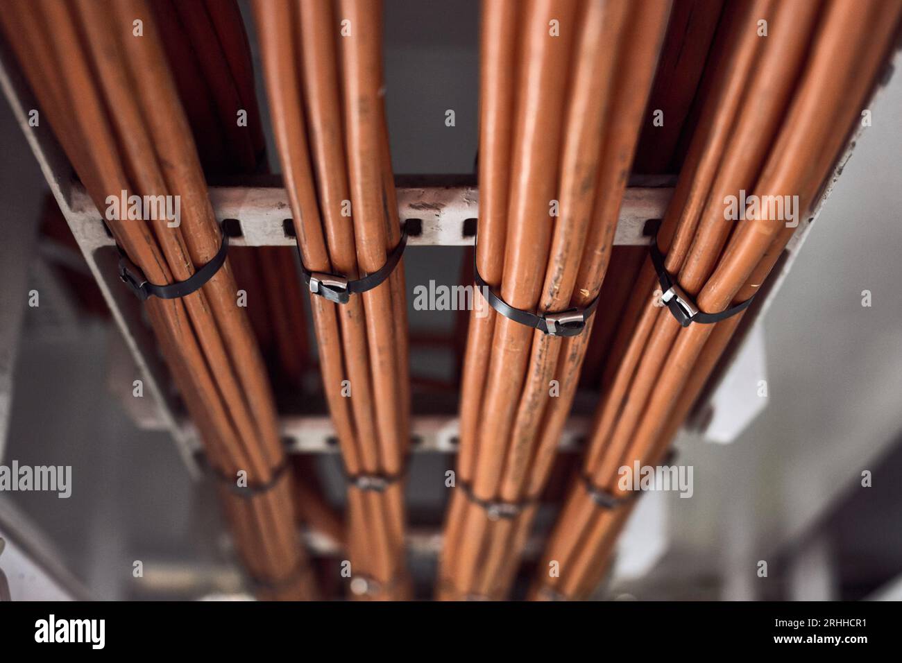 High power orange electric cables secured to a cable trunk Stock Photo ...