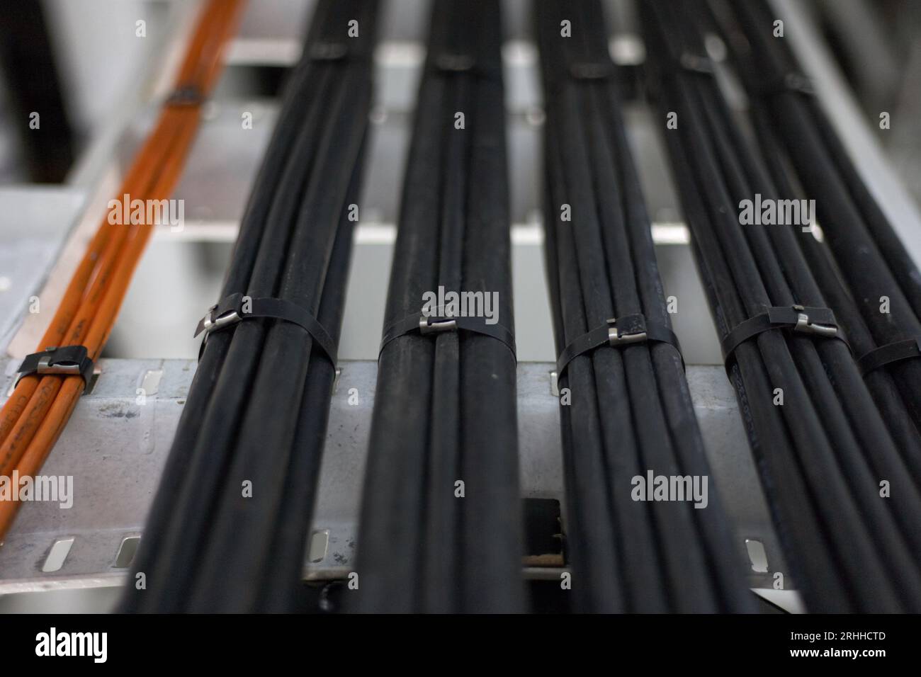 High power black electric cables secured to a cable trunk secured by ...