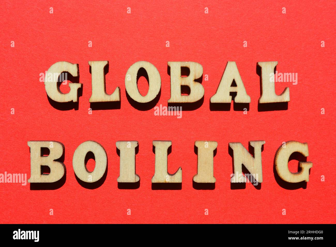 Global Boiling, words in wooden alphabet letters isolated on red ...