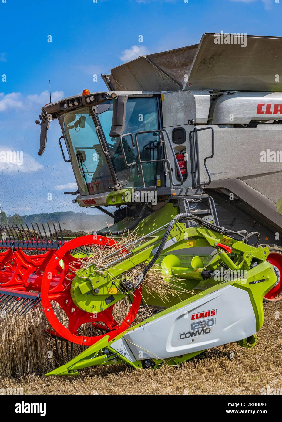 A Claas combine harvester working to harvest the corn on a summer’s day ...