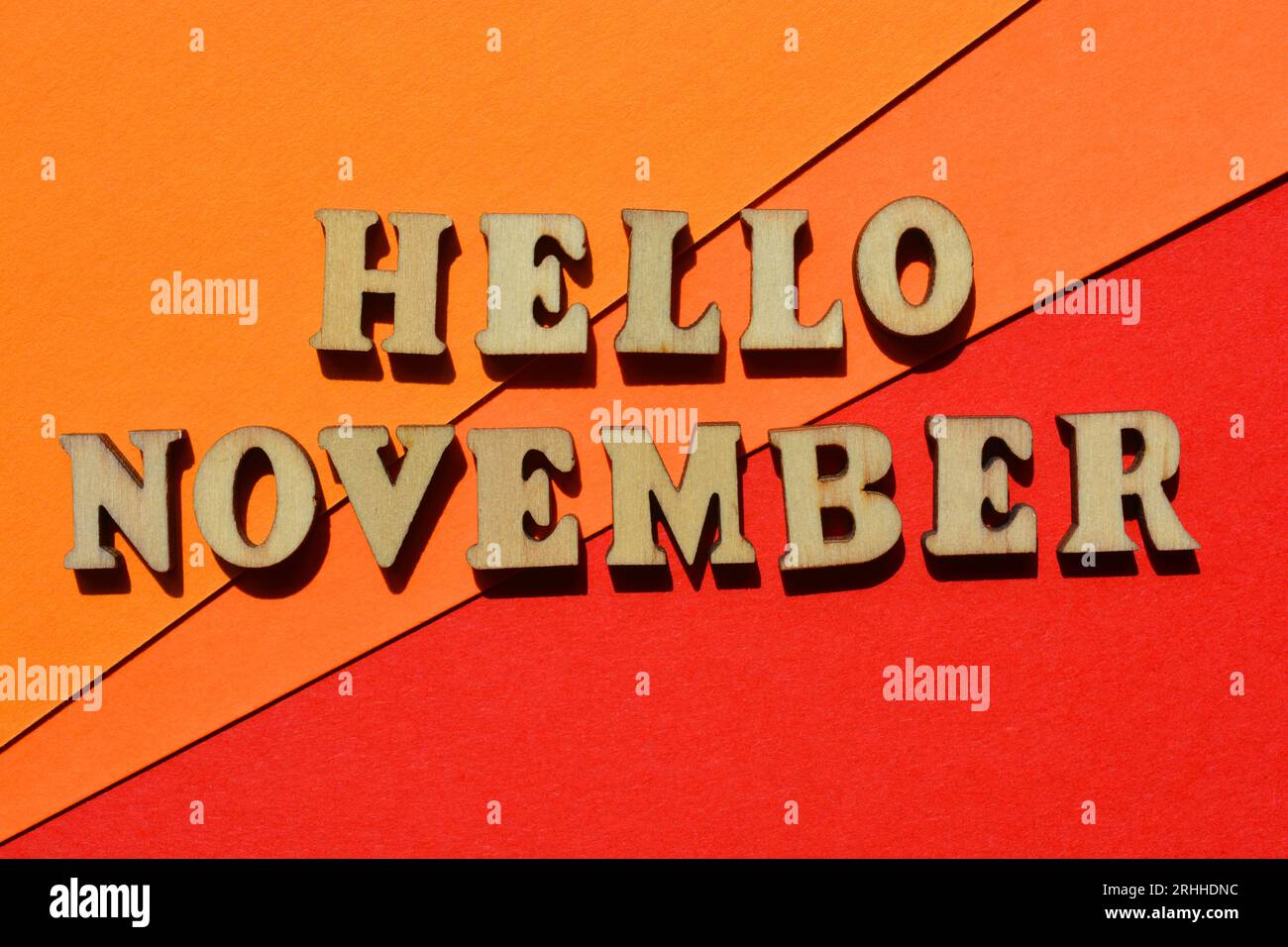 Hello November, words in wooden alphabet letters isolated on red and ...