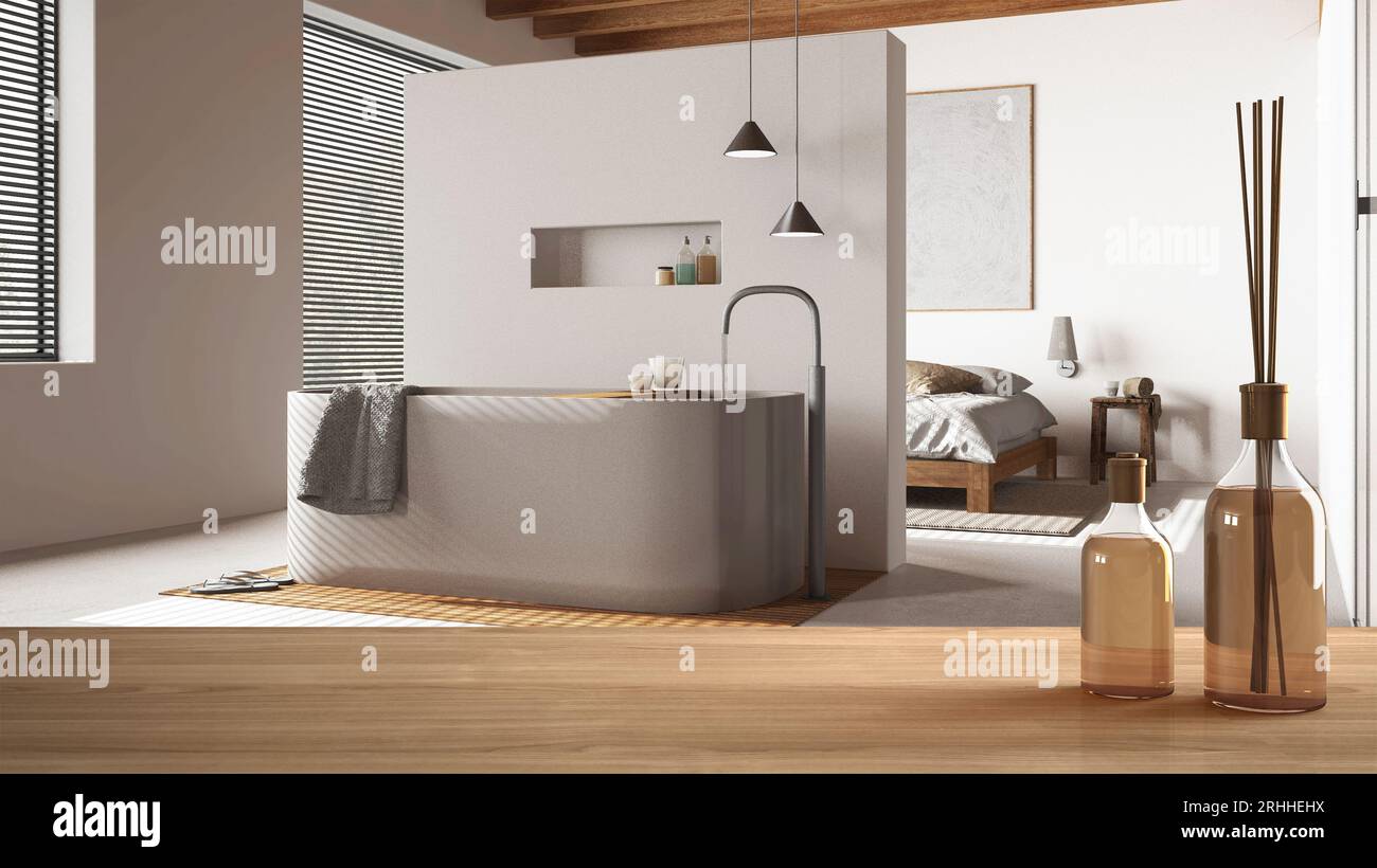 Wooden table top or shelf with aromatic sticks bottles over bedroom and bathroom with bathtub ...