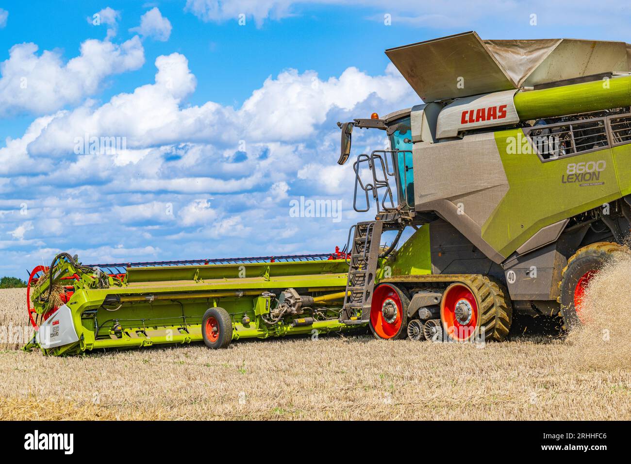A Claas combine harvester working to harvest the corn on a summer’s day ...