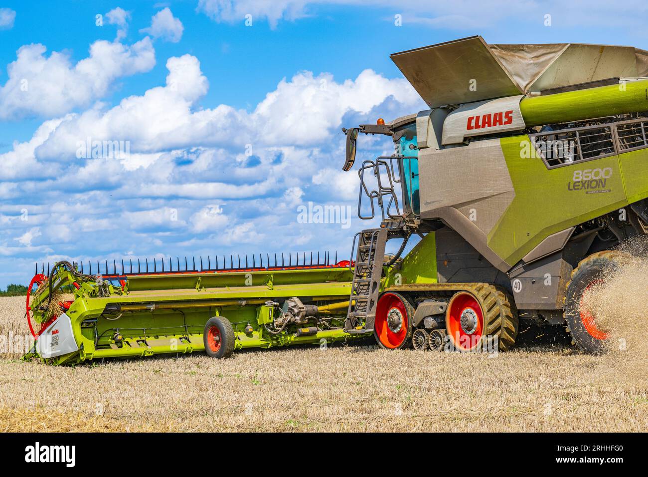 A Claas combine harvester working to harvest the corn on a summer’s day ...