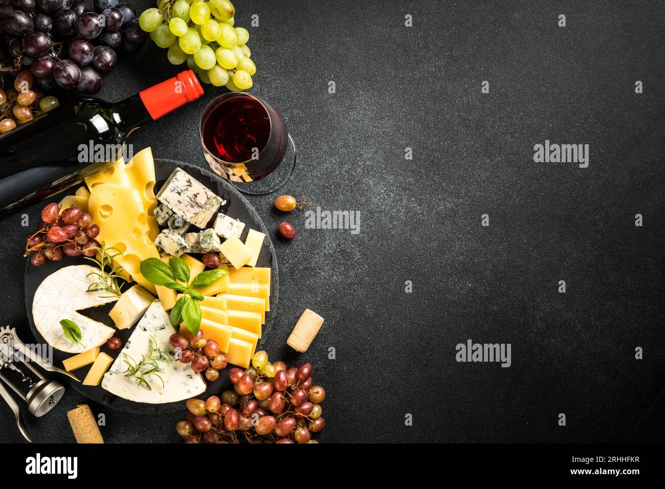 Cheese platter with craft cheese assortment on slate board at black ...