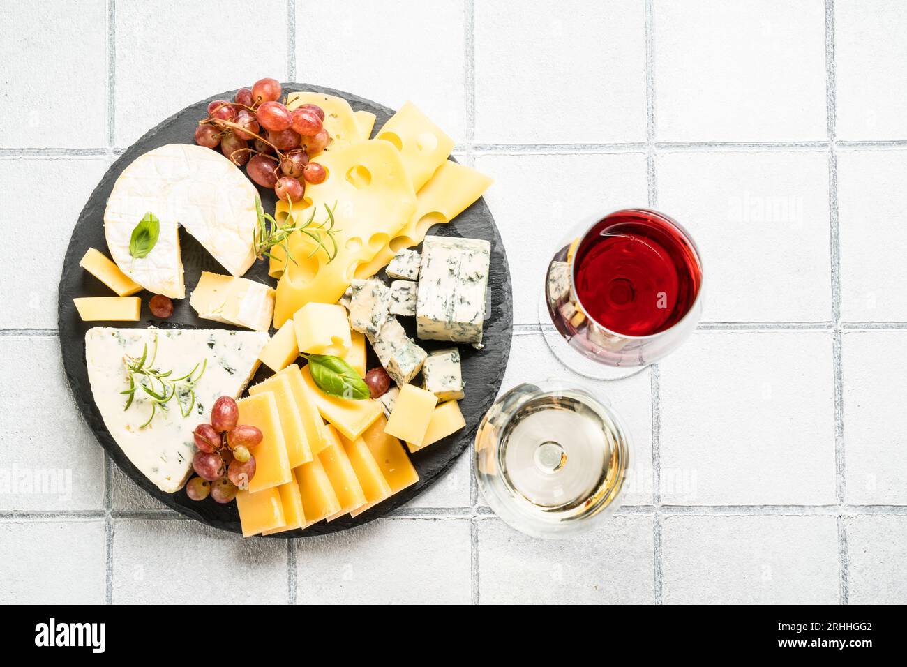 Cheese platter with craft cheese assortment on slate board at white ...