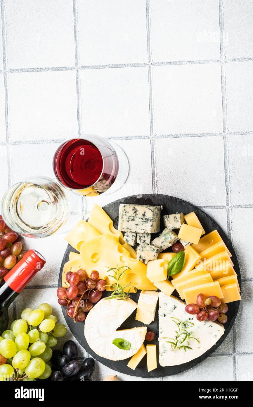 Cheese platter with craft cheese assortment on slate board at white ...