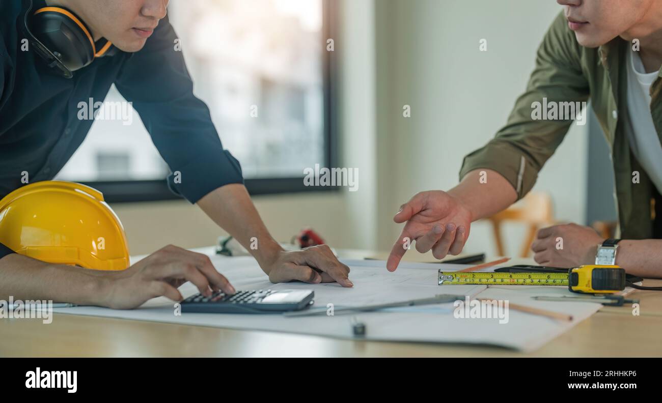 Closeup hand of engineer team with construction work plan discussion ...