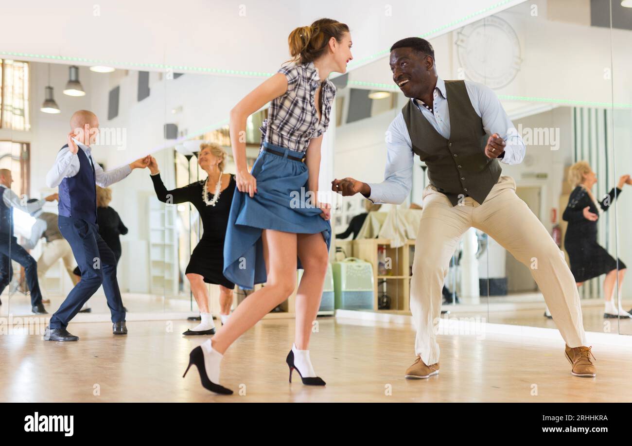 Woman with african man practising charleston dancing Stock Photo - Alamy