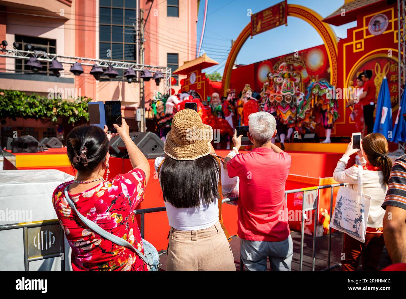 Thai people and tourists busily photograph the dance and singing show ...