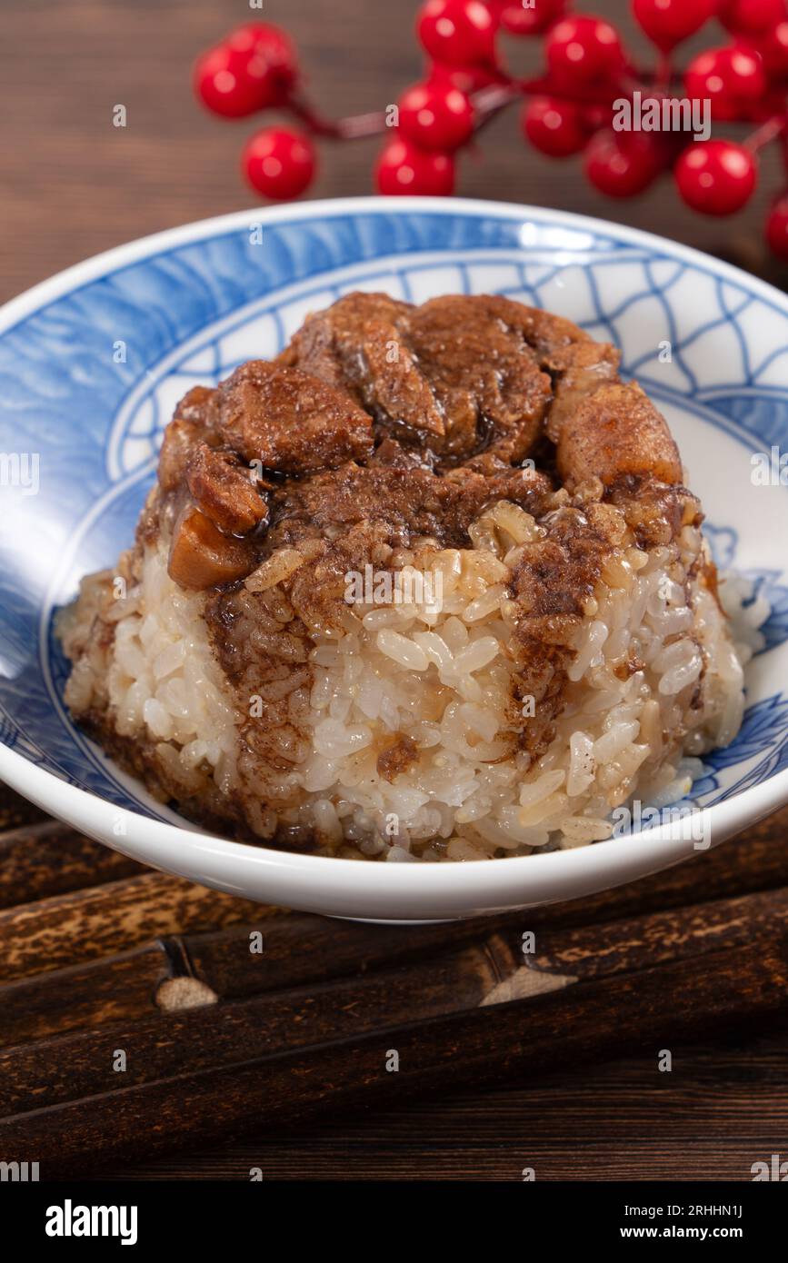 Migao, tube rice cake, rice pudding in a bowl topped with minced pork ...