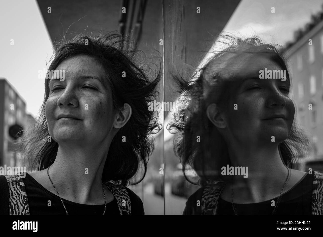 A portrait of a woman standing next to window Stock Photo - Alamy