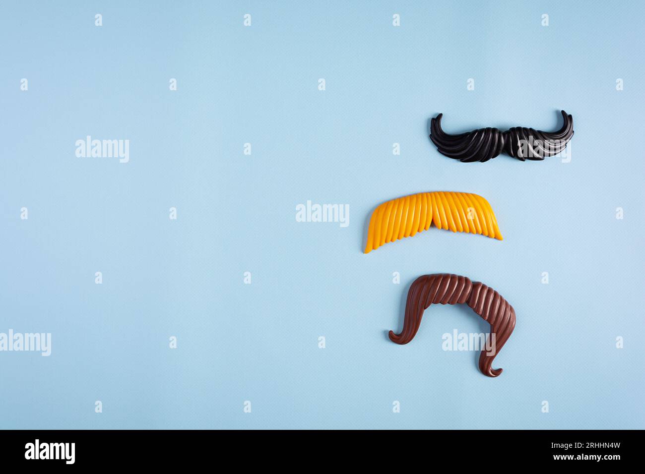 Curly mustaches on colorful background. Fake mustache. Top view Stock ...