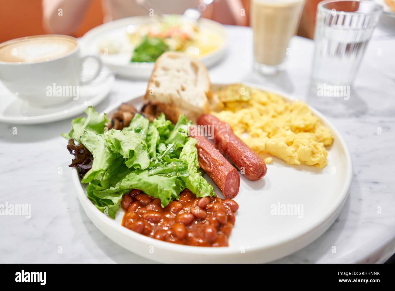 Simple American style Breakfast with sausages, scrambled eggs, baked ...