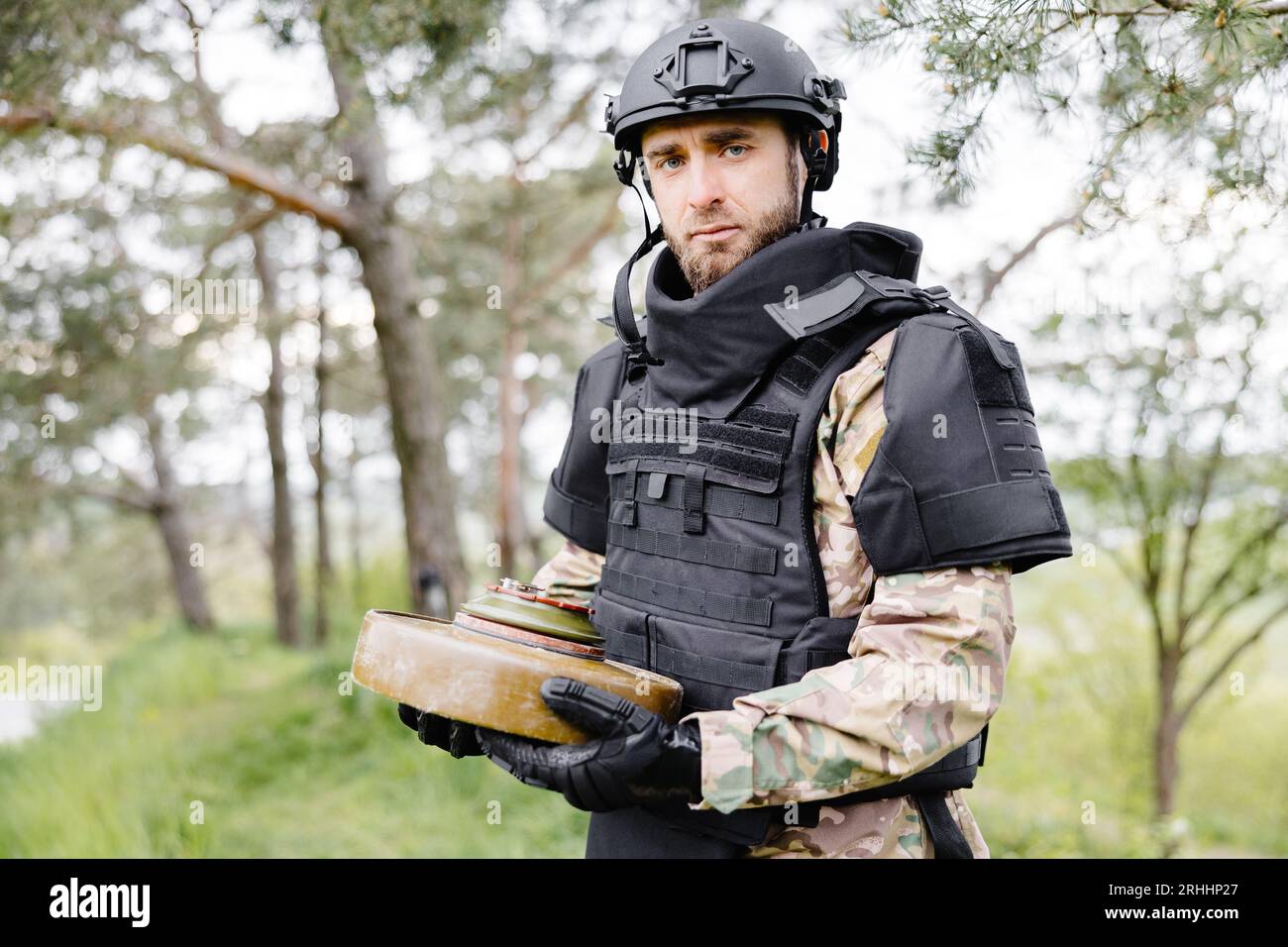 A man in a special suit works with a detector and found an explosive ...