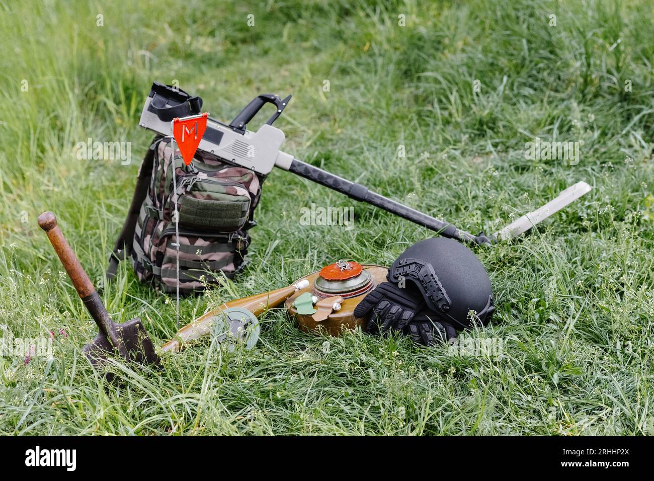 Explosive devices and a metal detector lie on the background of a ...