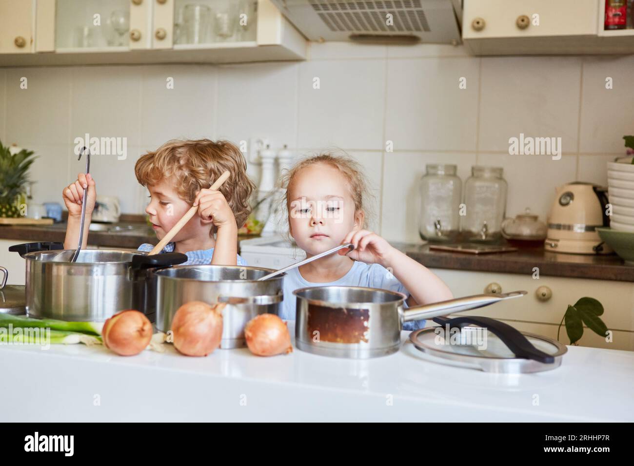 Brother sister cooking preparing food hi-res stock photography and ...