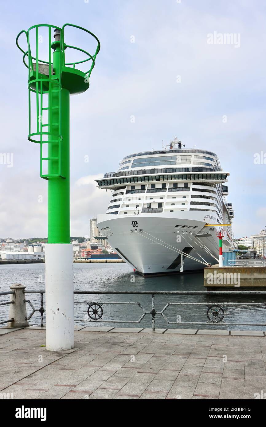 Green navigation tower at the entrance to the port with the MSC ...