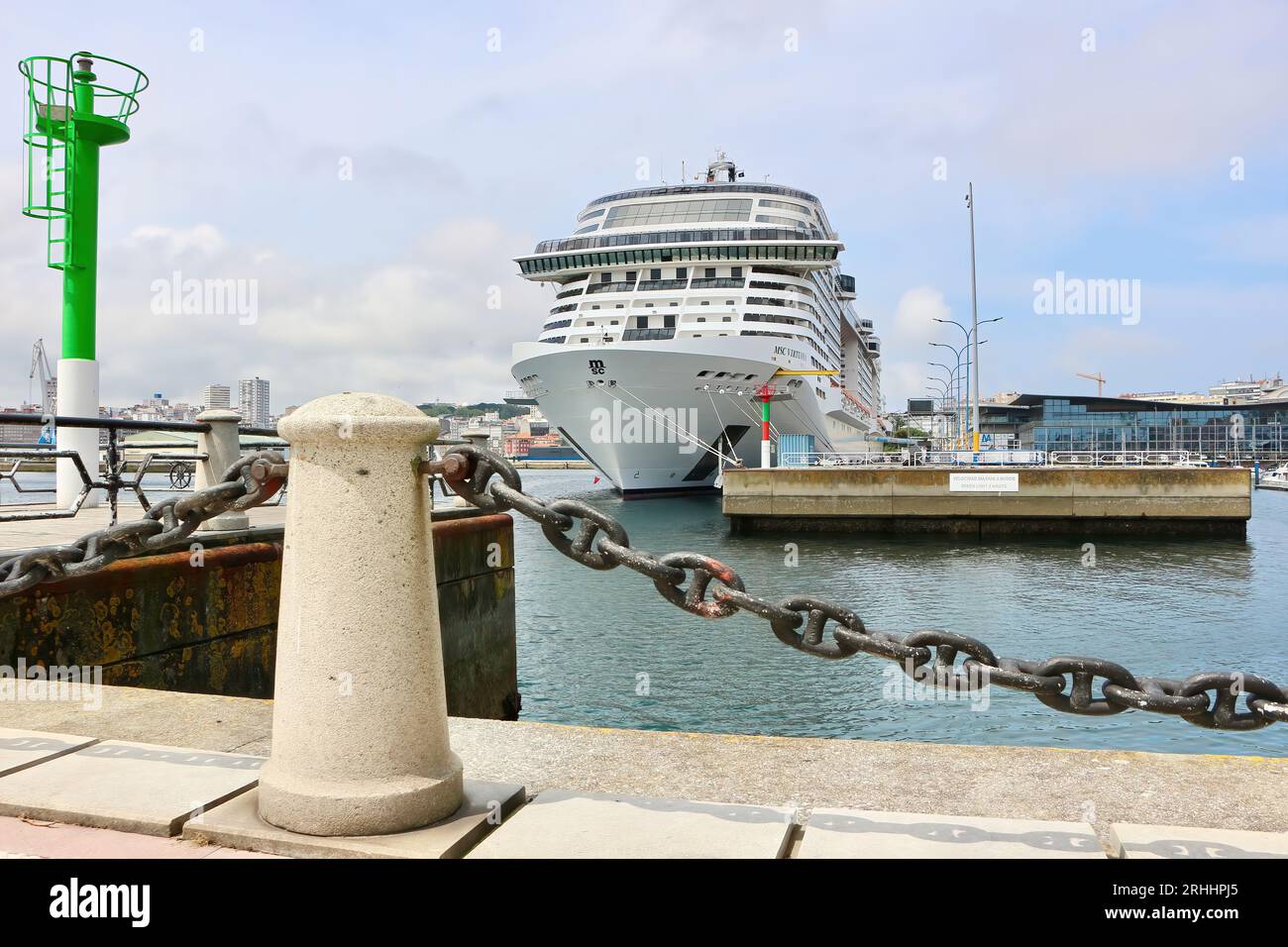 Green navigation tower at the entrance to the port with the MSC ...