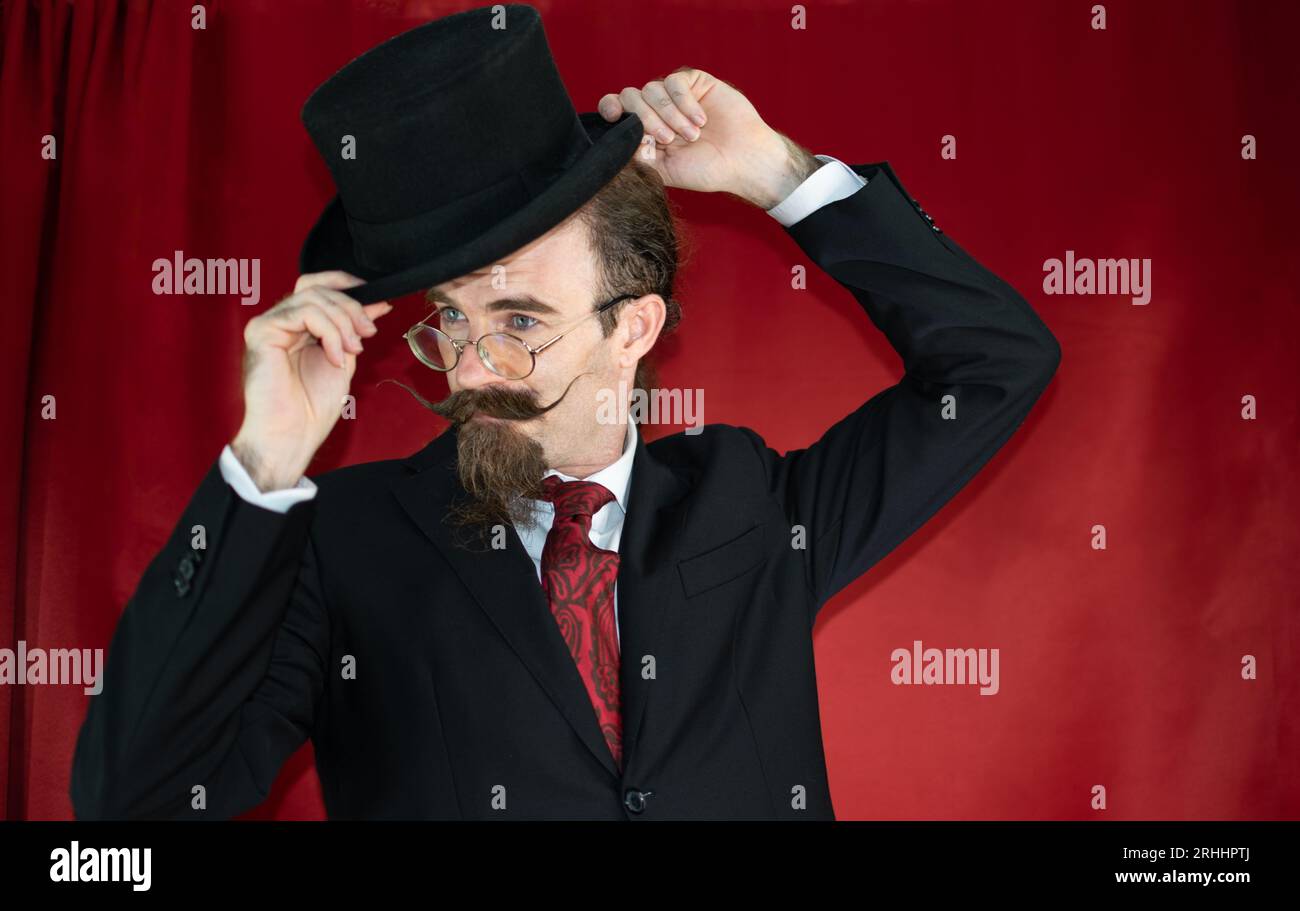 Vintage Caucasian Magician with top hat, glasses and mustache posing ...