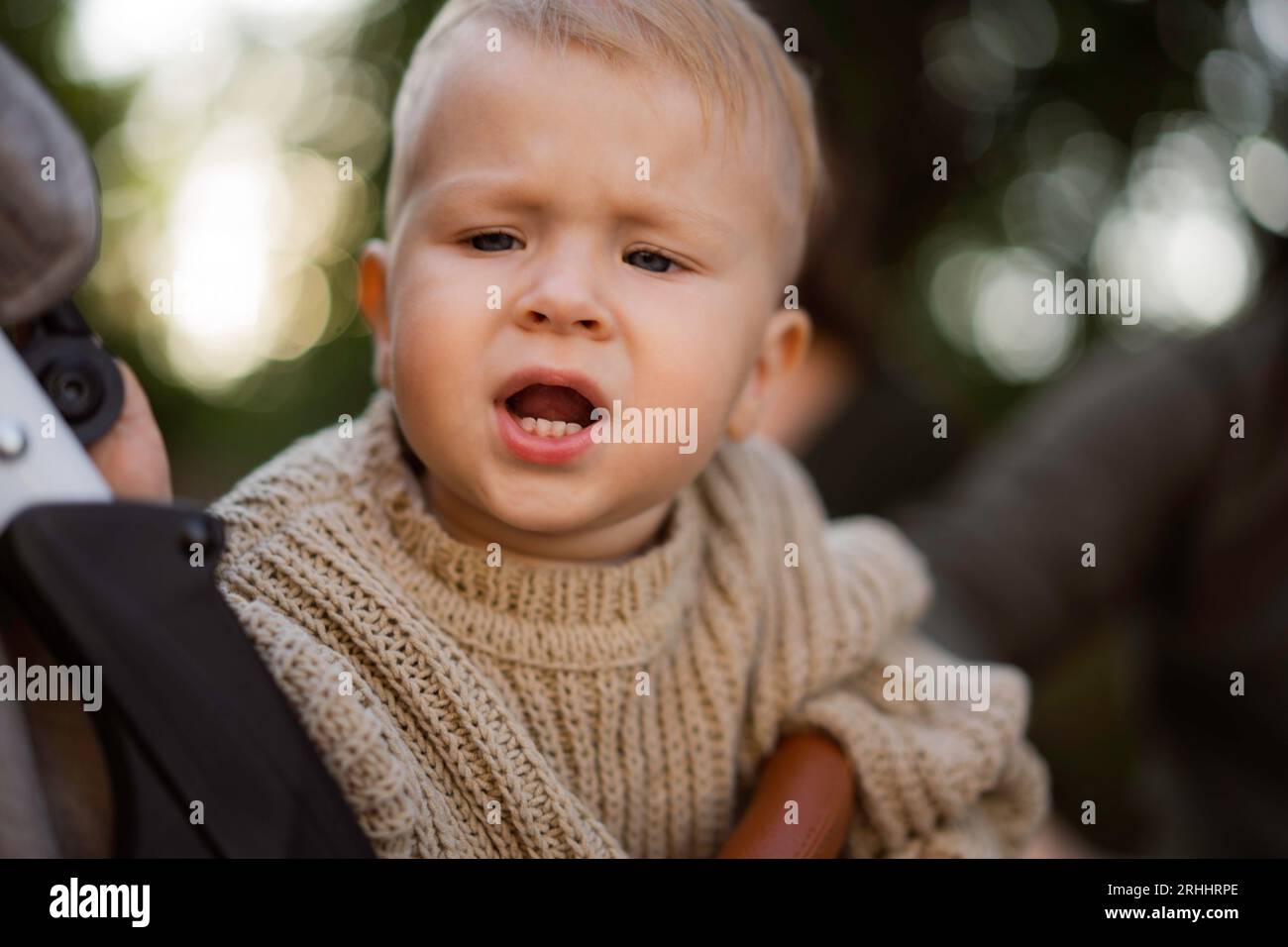 cute caucasian baby boy sitting in a buggy scared or upset Stock Photo ...