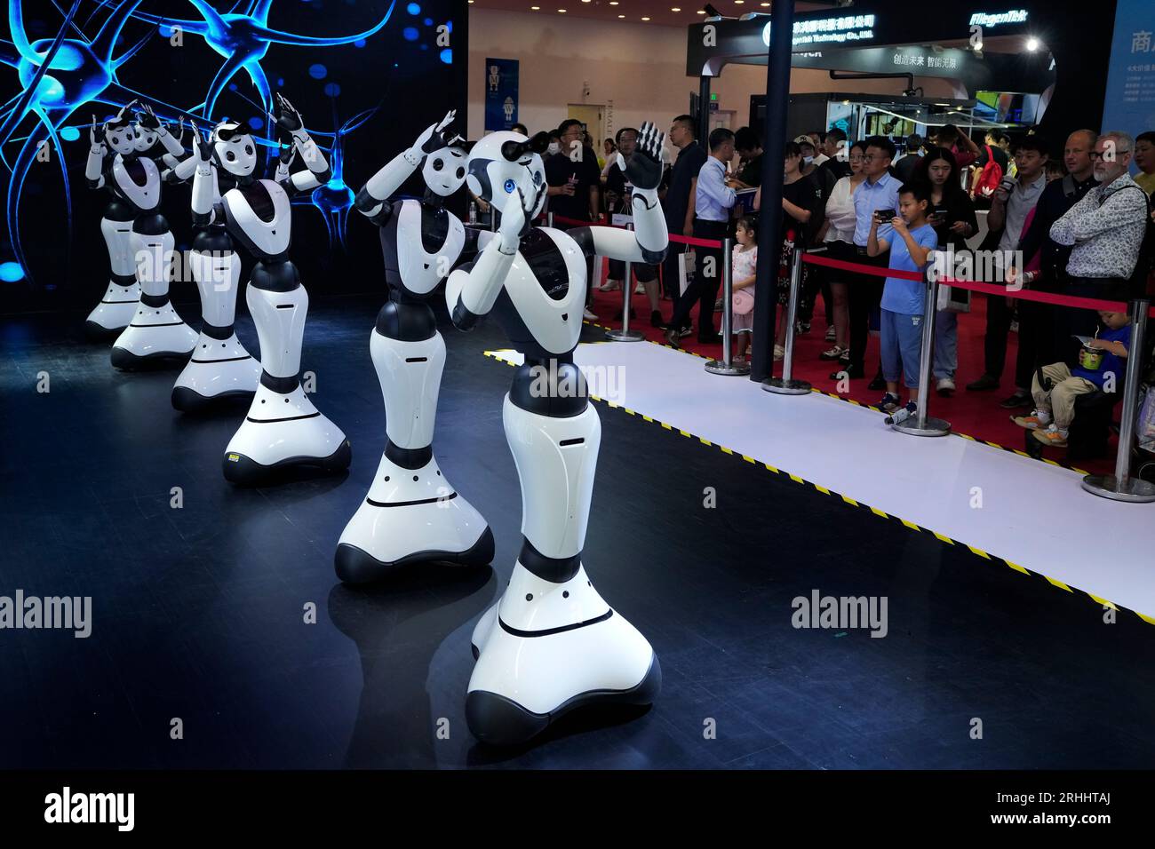 Visitors look at robots perform on stage during the annual World Robot ...