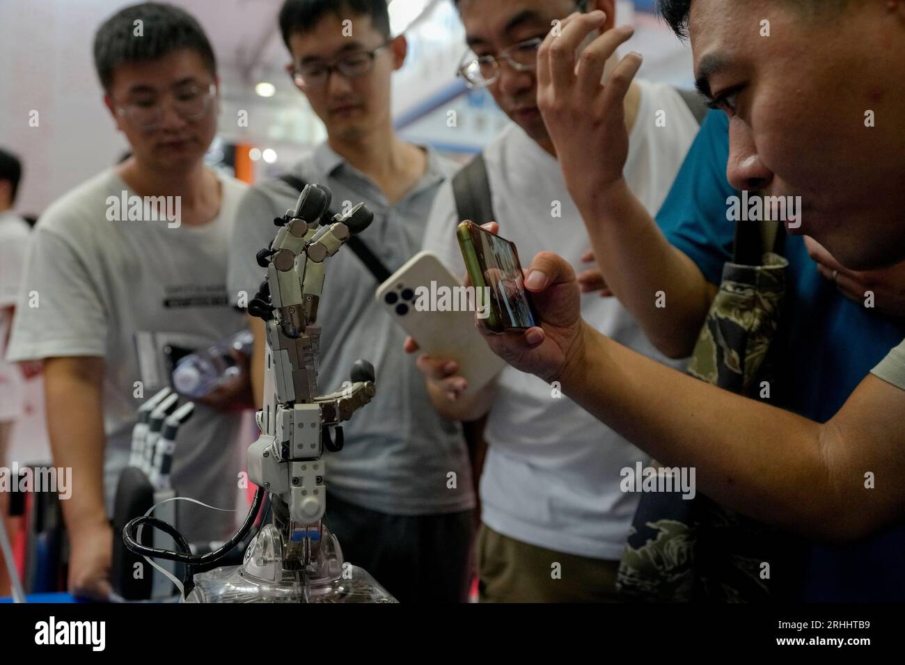 Visitors look at robot palms during the annual World Robot Conference ...