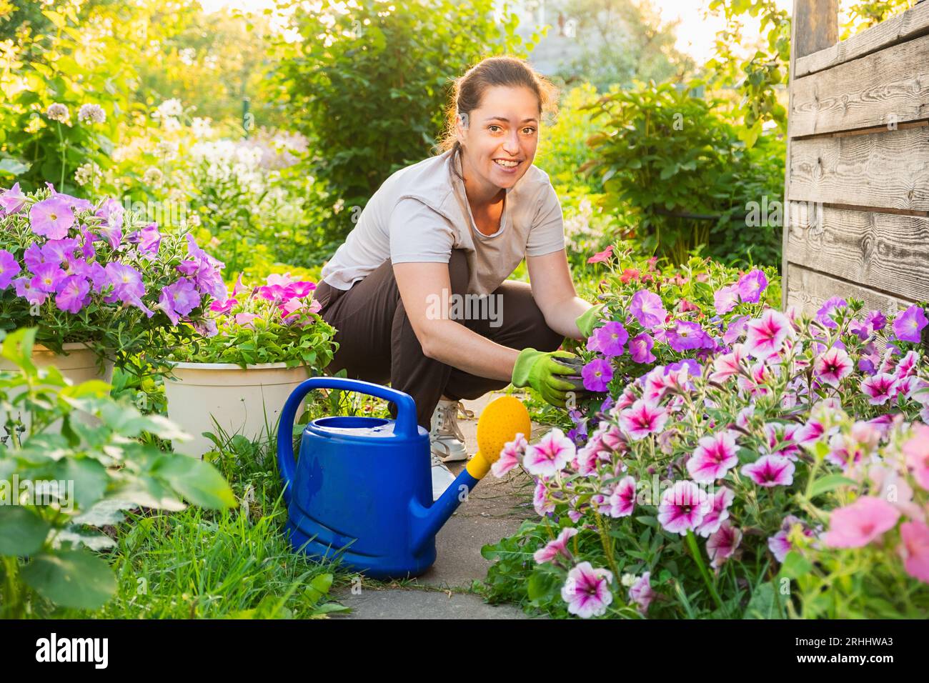Gardening and agriculture concept. Young woman farm worker gardening ...