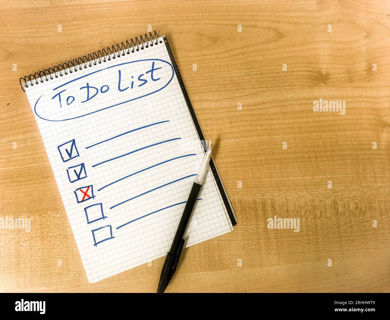 to do list checklist hand written on notepad paper lay on wooden table ...