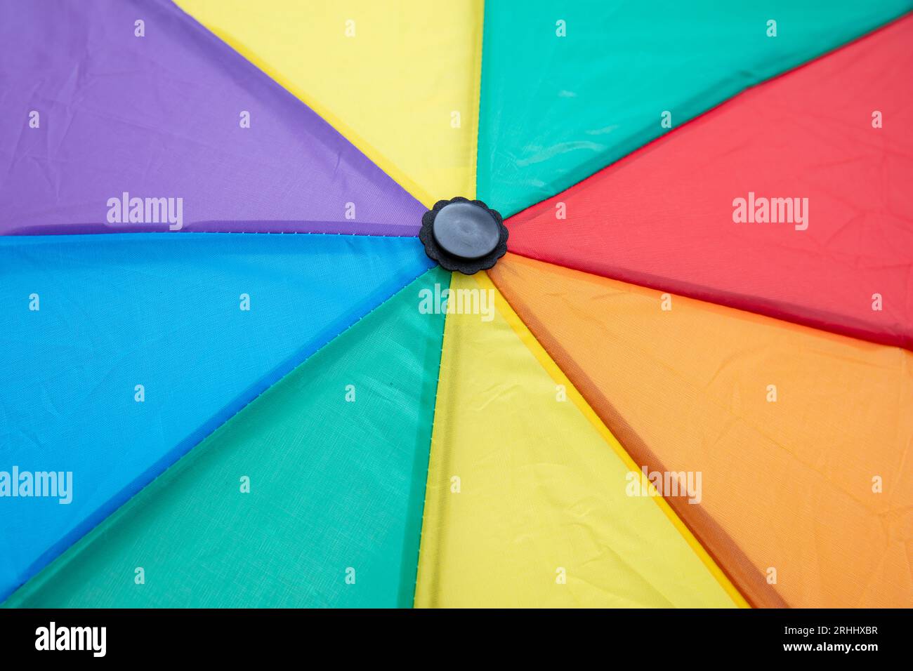 Rainbow colors umbrella closeup, a vibrant display of colors background ...