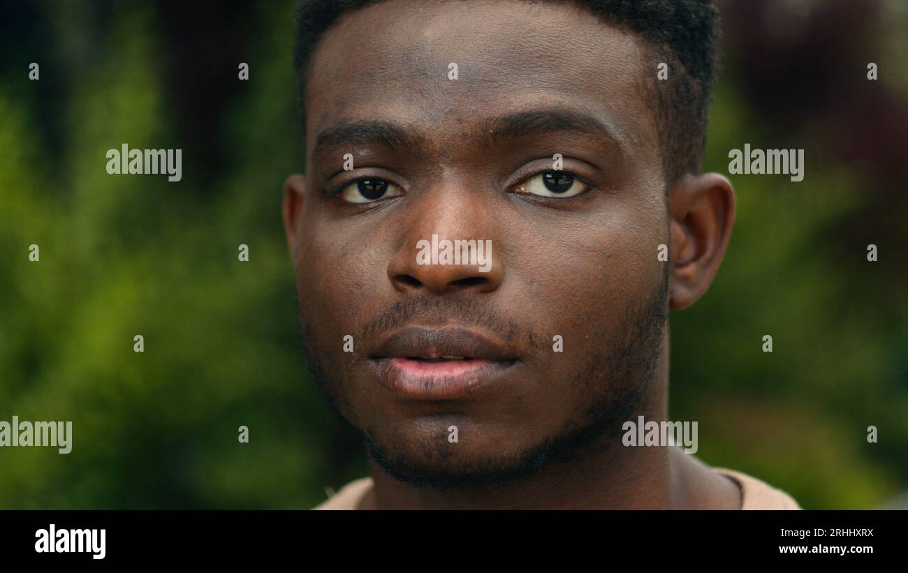 Close up male face serious millennial young African American ethnic guy ...